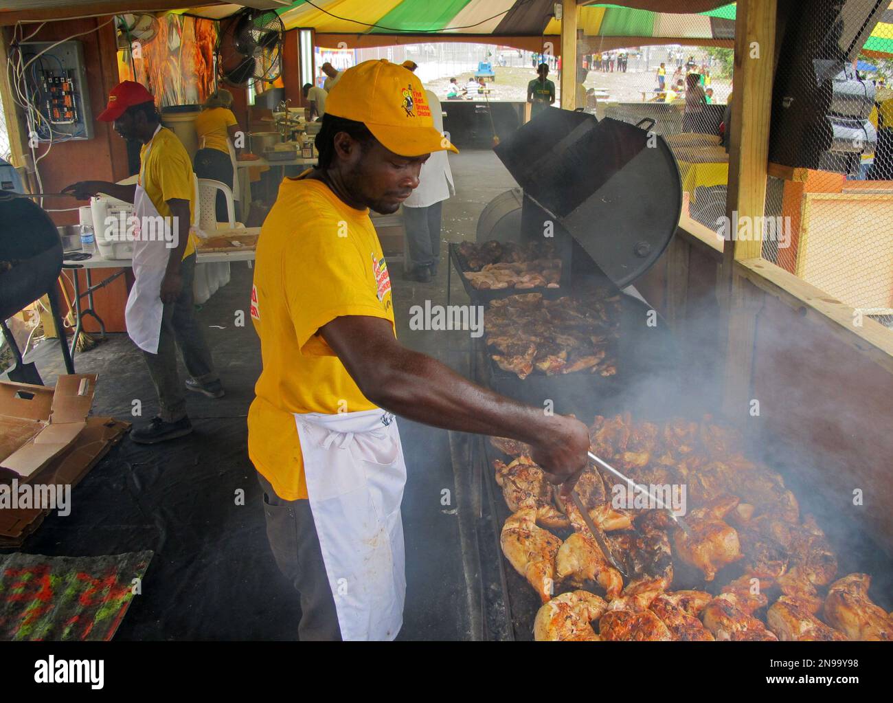 Ian Marshall cooks the Jamaican specialty of "pan chicken" at a food ...