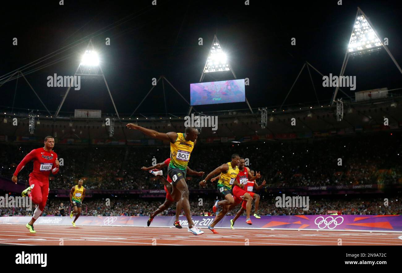 Jamaica's Usain Bolt, third from left, crosses the finish line to win ...