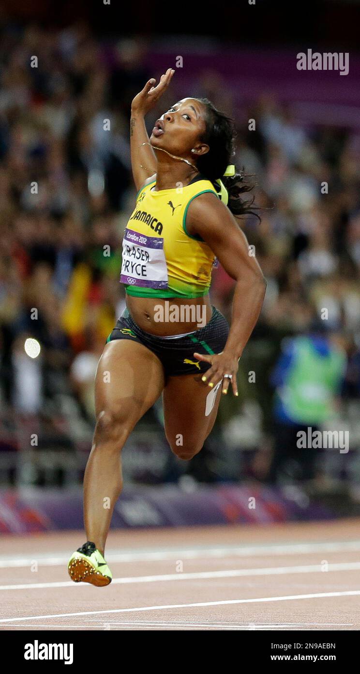 Jamaica's Shelly-Ann Fraser-Pryce goes to cross the finish line to win gold in the women's 100 ...