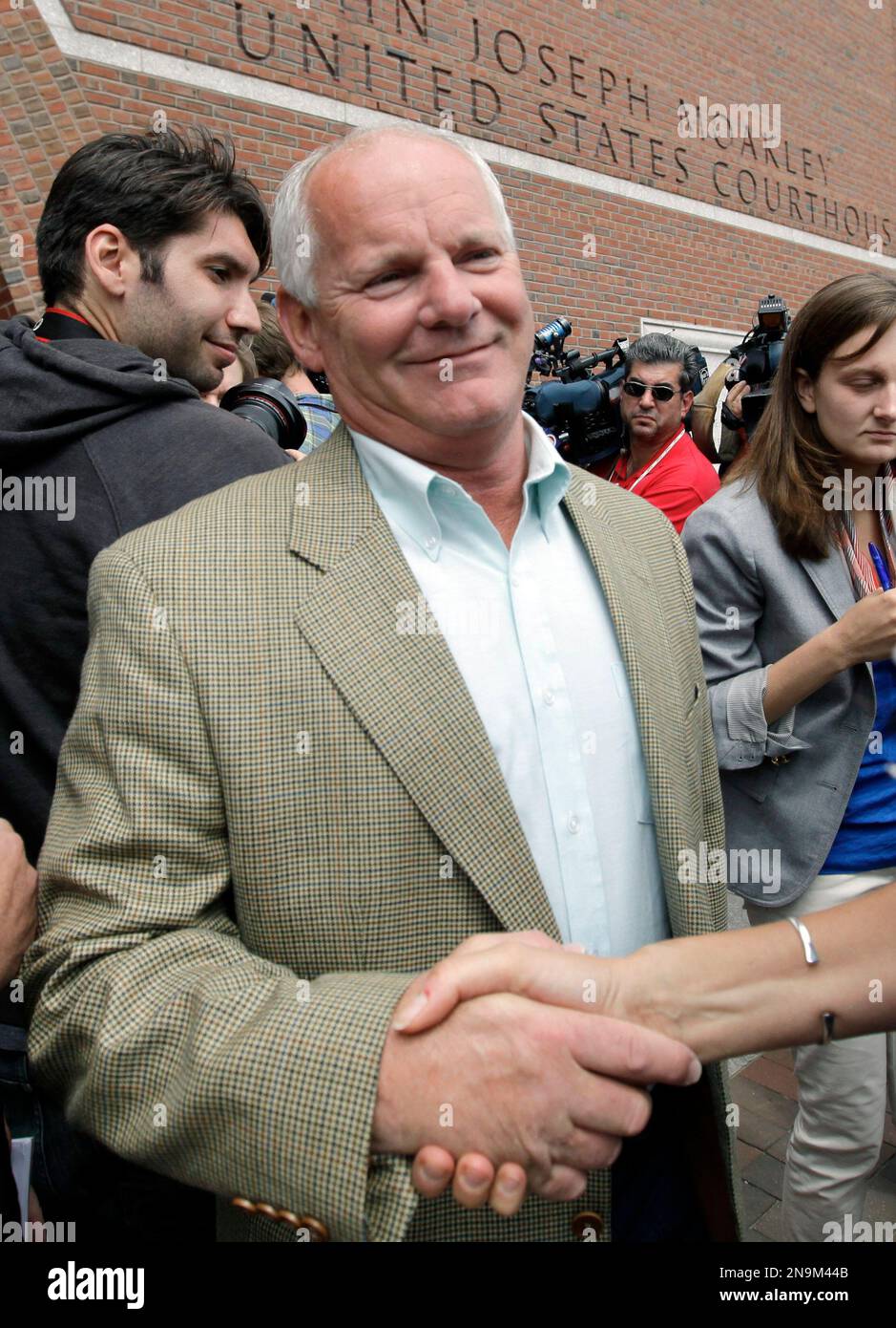 Victim Stephen Rakes receives a handshake outside federal court in ...