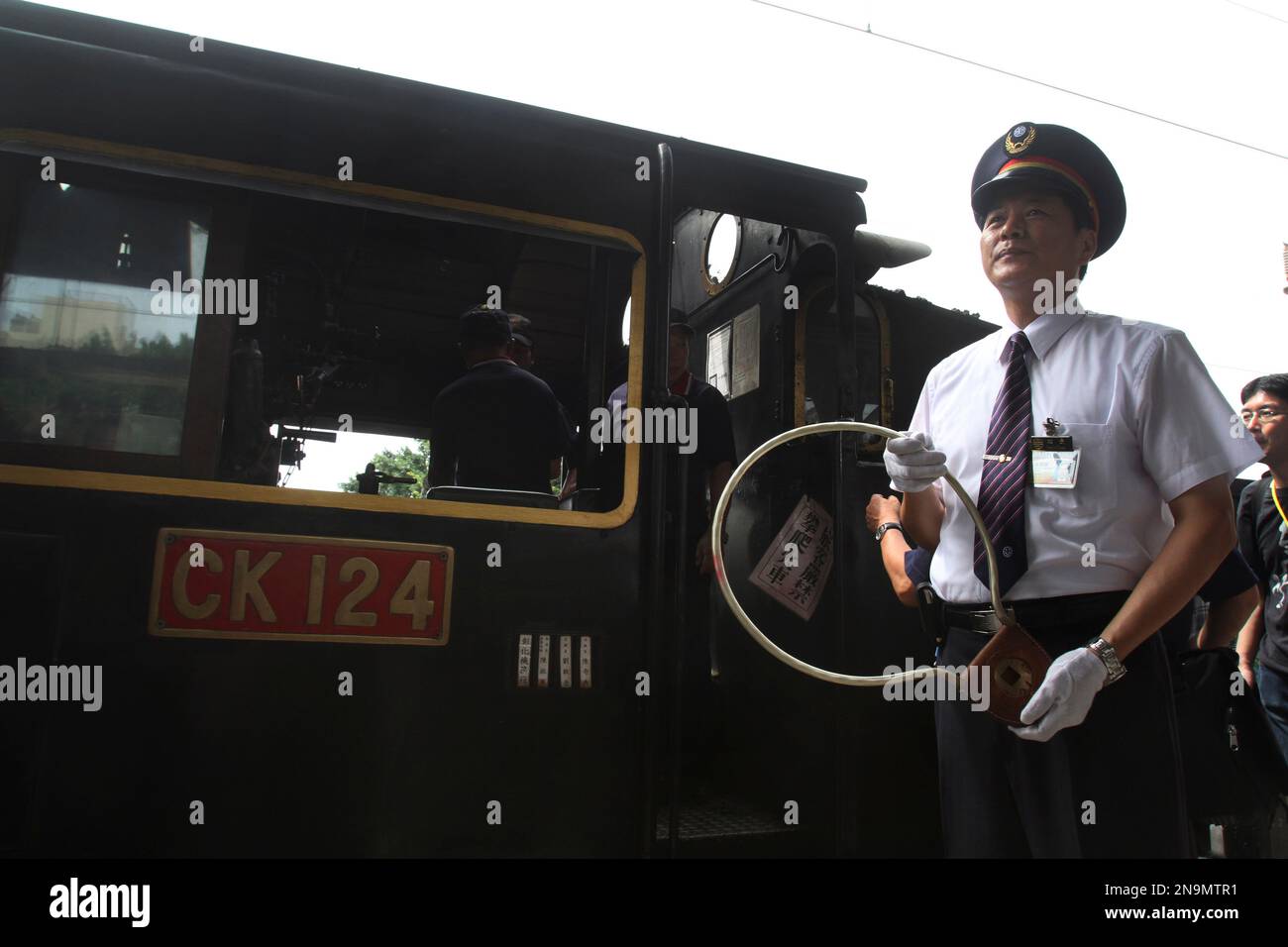 In this Thursday, June, 7, 2012 photo, a train conductor of Taiwan ...