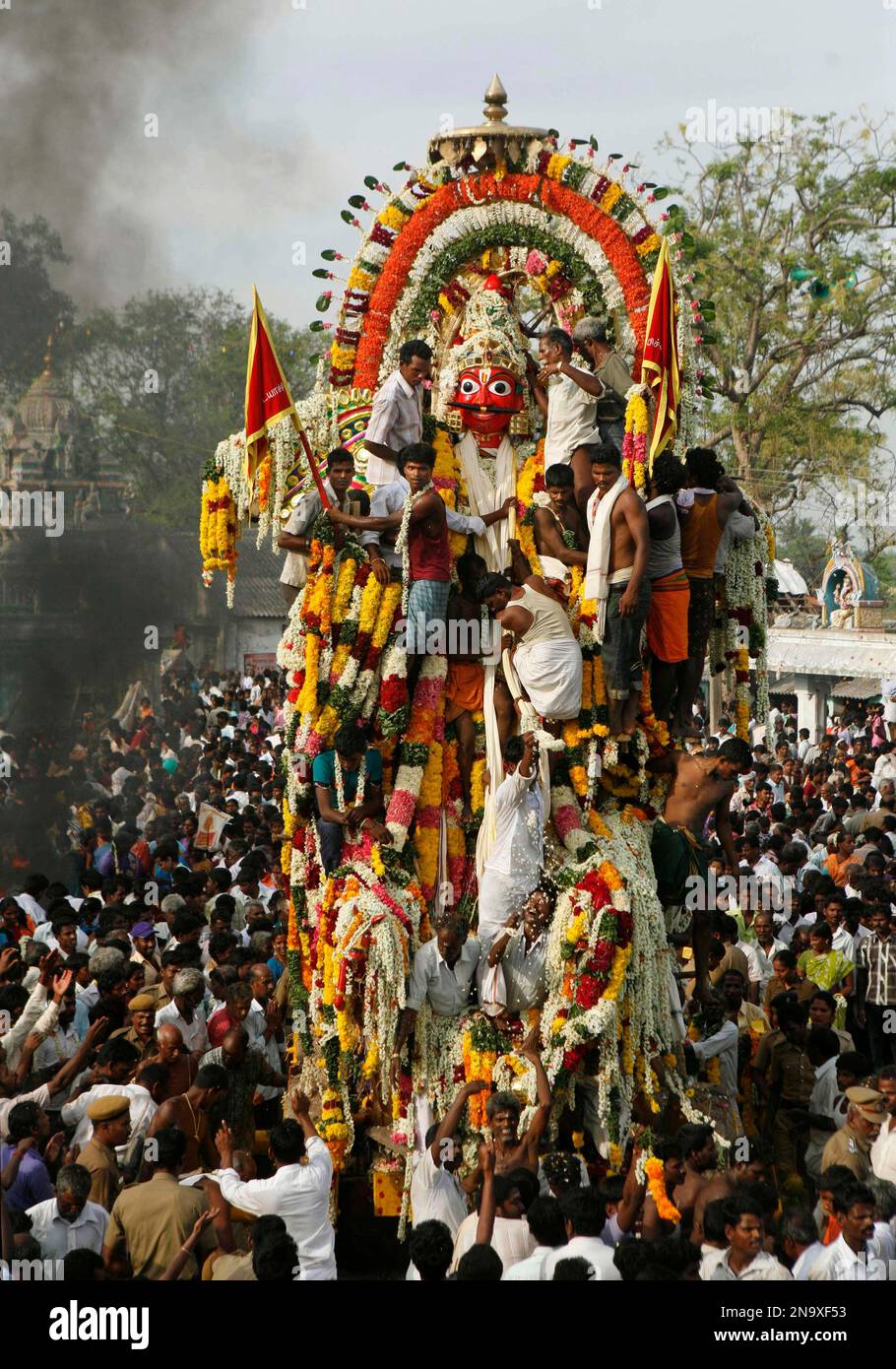 An idol of warrior god Aravan is taken in a chariot during the annual ...