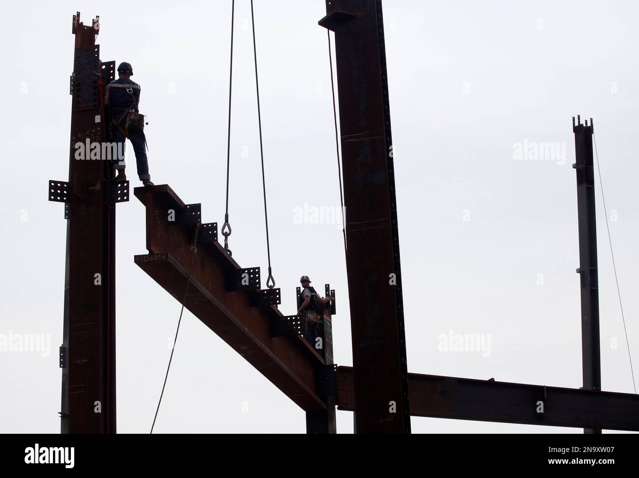 In this March 23, 2012, photo ironworkers connects steel beams at the ...