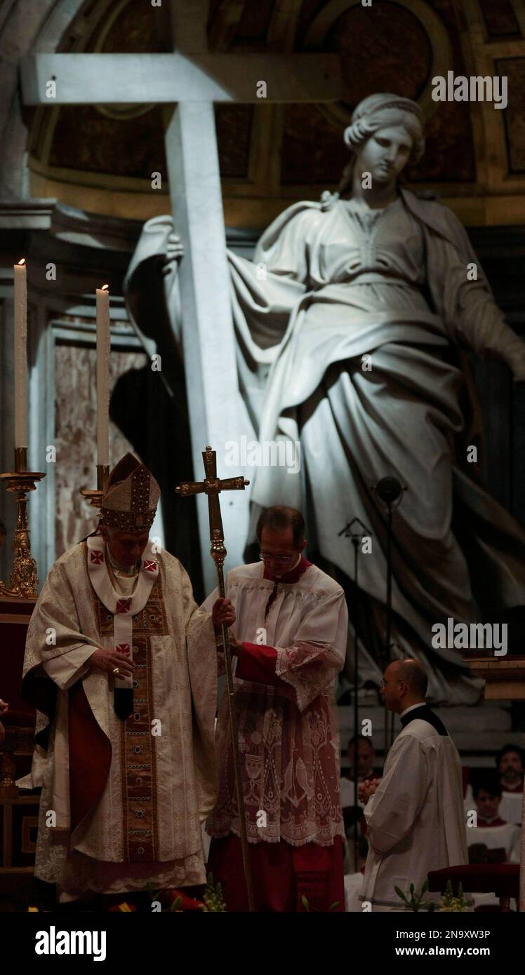 Pope Benedict XVI, left, walks with his pastoral staff during a ...