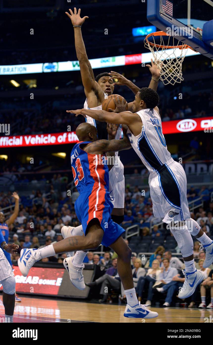 Detroit Pistons guard Walker Russell, left, puts up a shot in front of ...