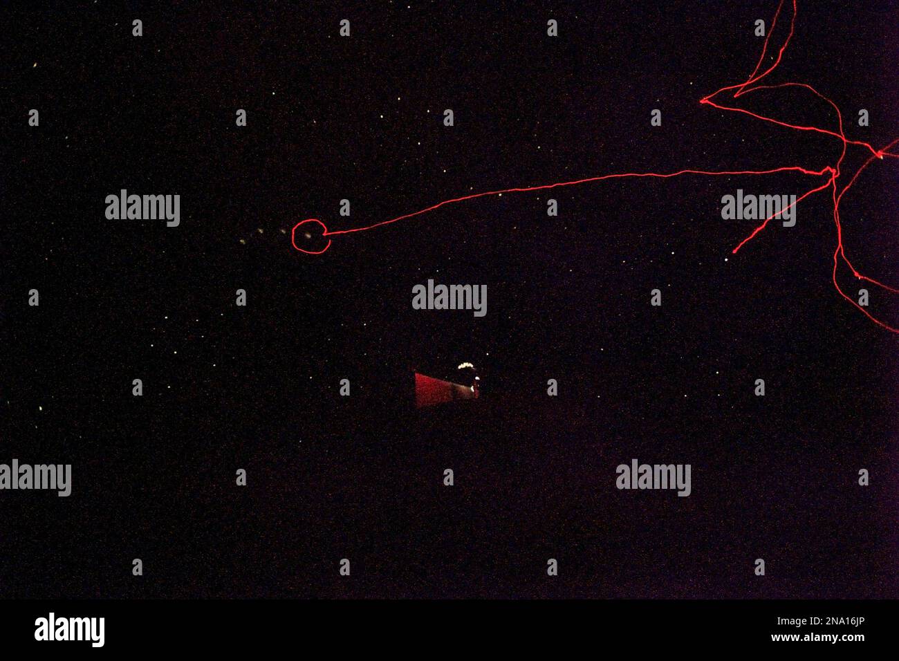 In this photo taken Tuesday, April 10, 2012, a laser pointer's path is ...