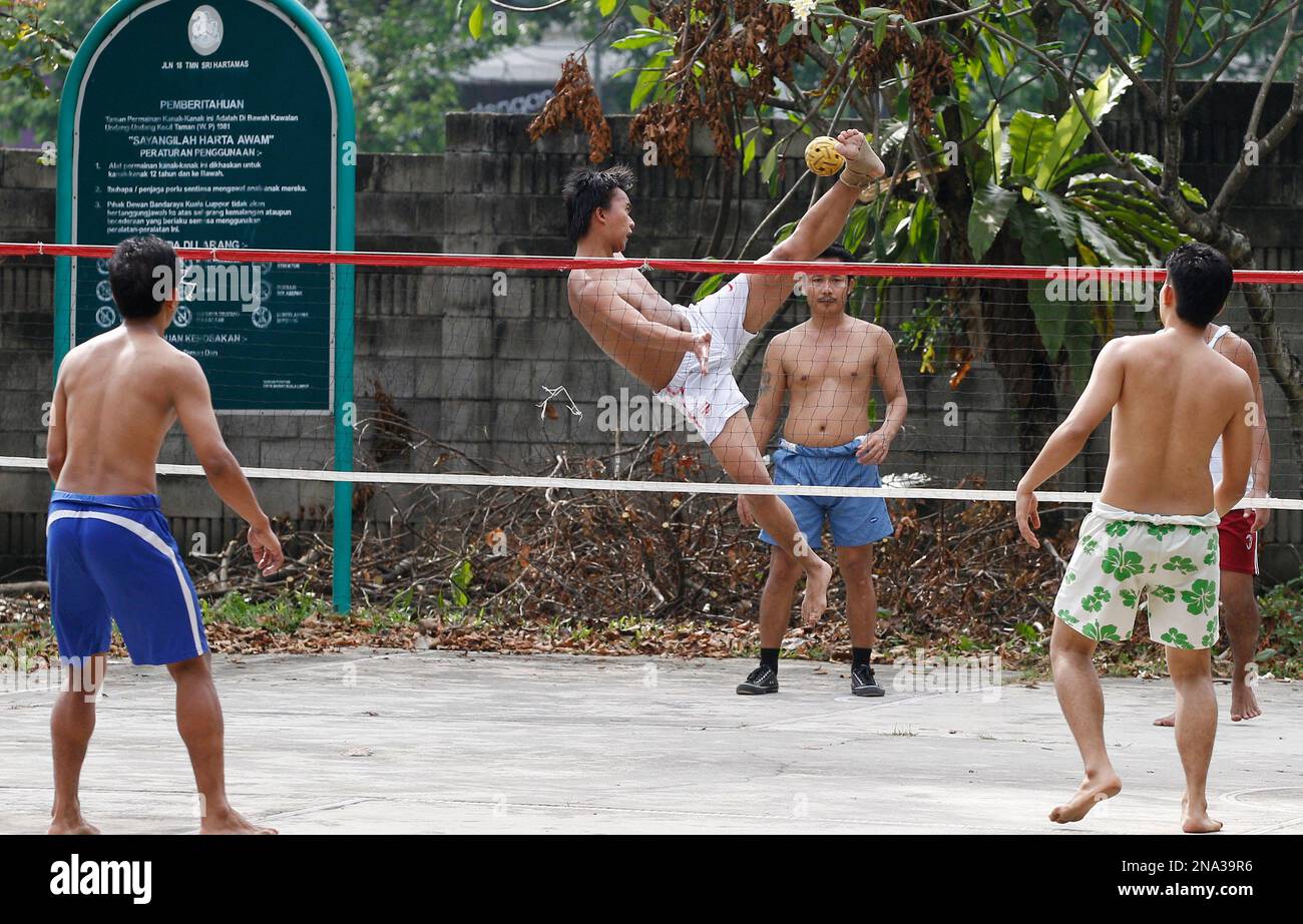 Myanmar workers play a traditional game of chin lone in a park in Kuala ...