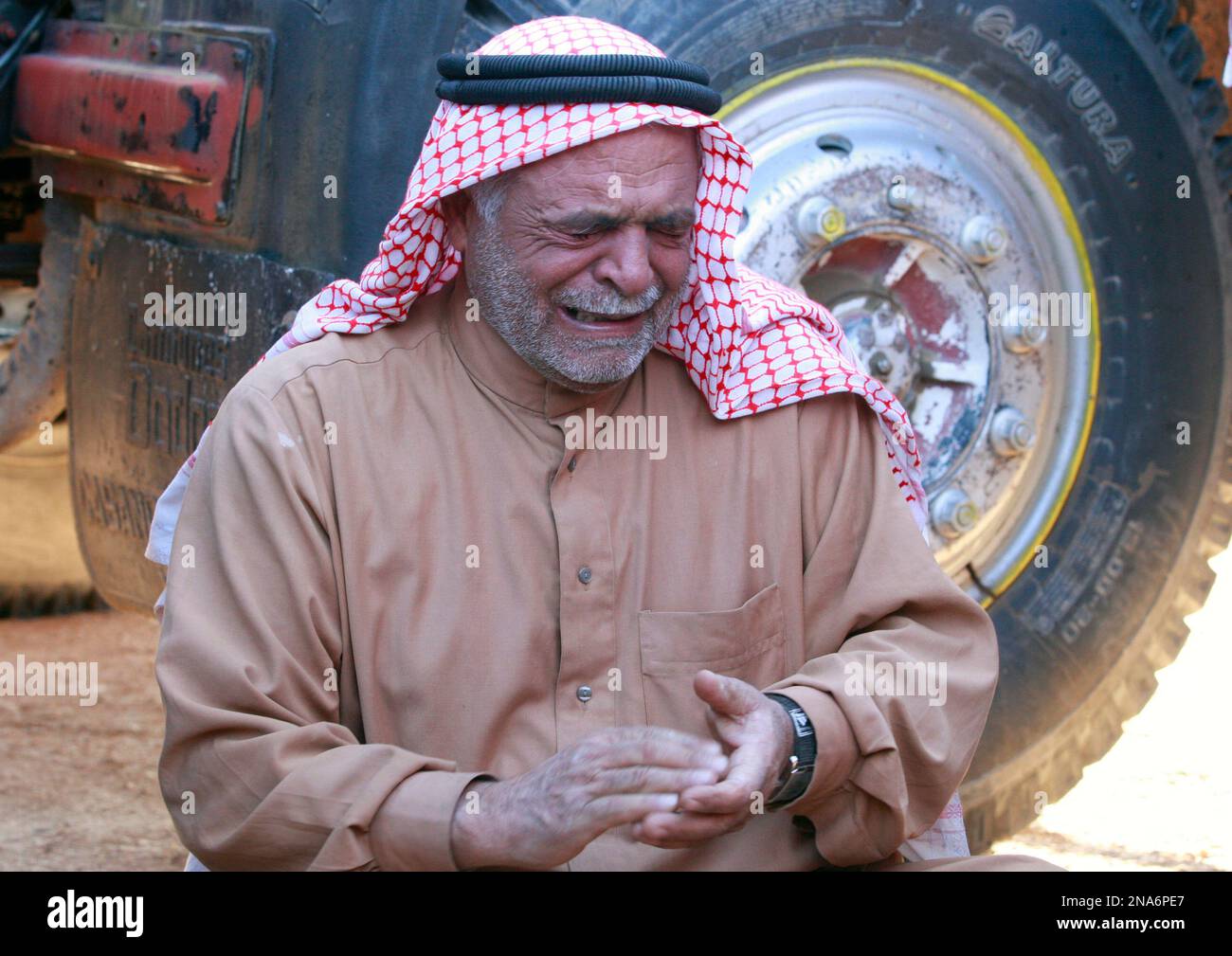 A man grieves for security forces killed in an attack in Haditha, Iraq ...