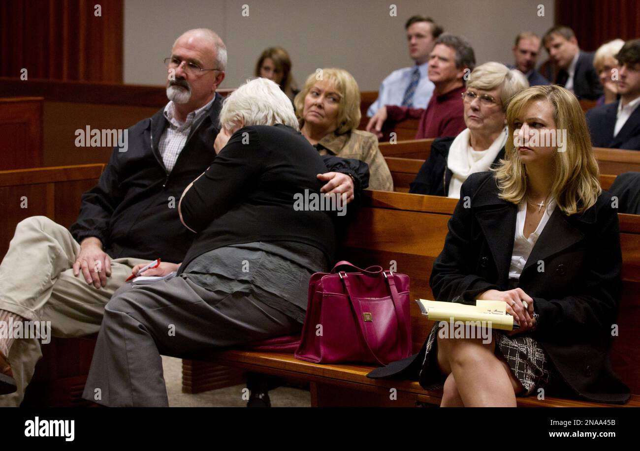 Glenda Watson, second from left, is hugged by her husband David Watson ...