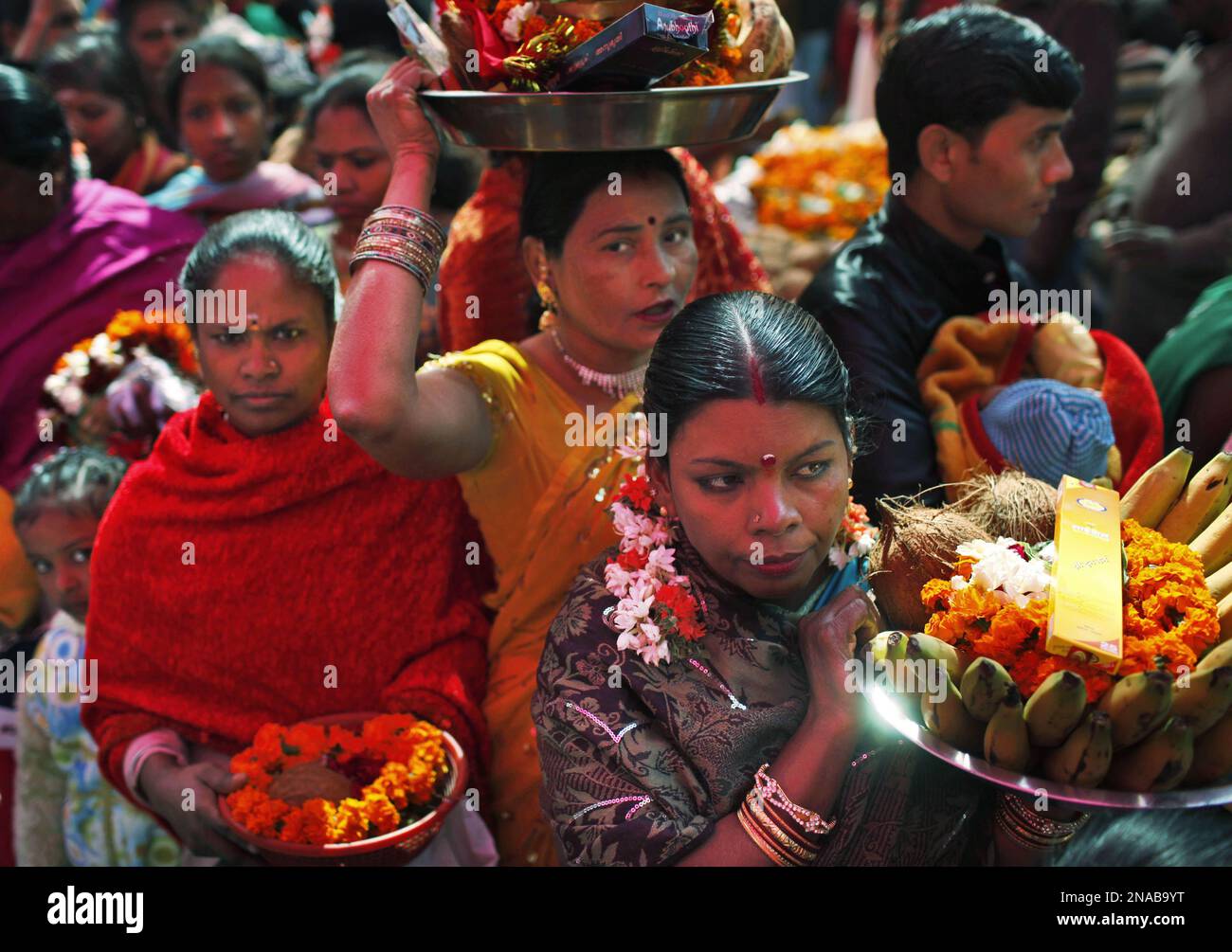 Tamil Hindu worshippers line up with offerings during a blessing ritual ...