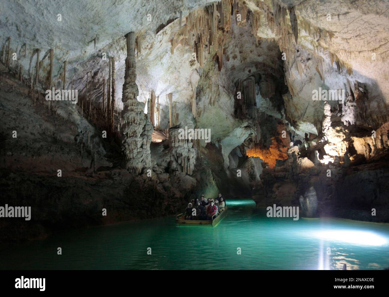 Arab tourists take a boat tour in the lower cave of the Jeita Grotto ...
