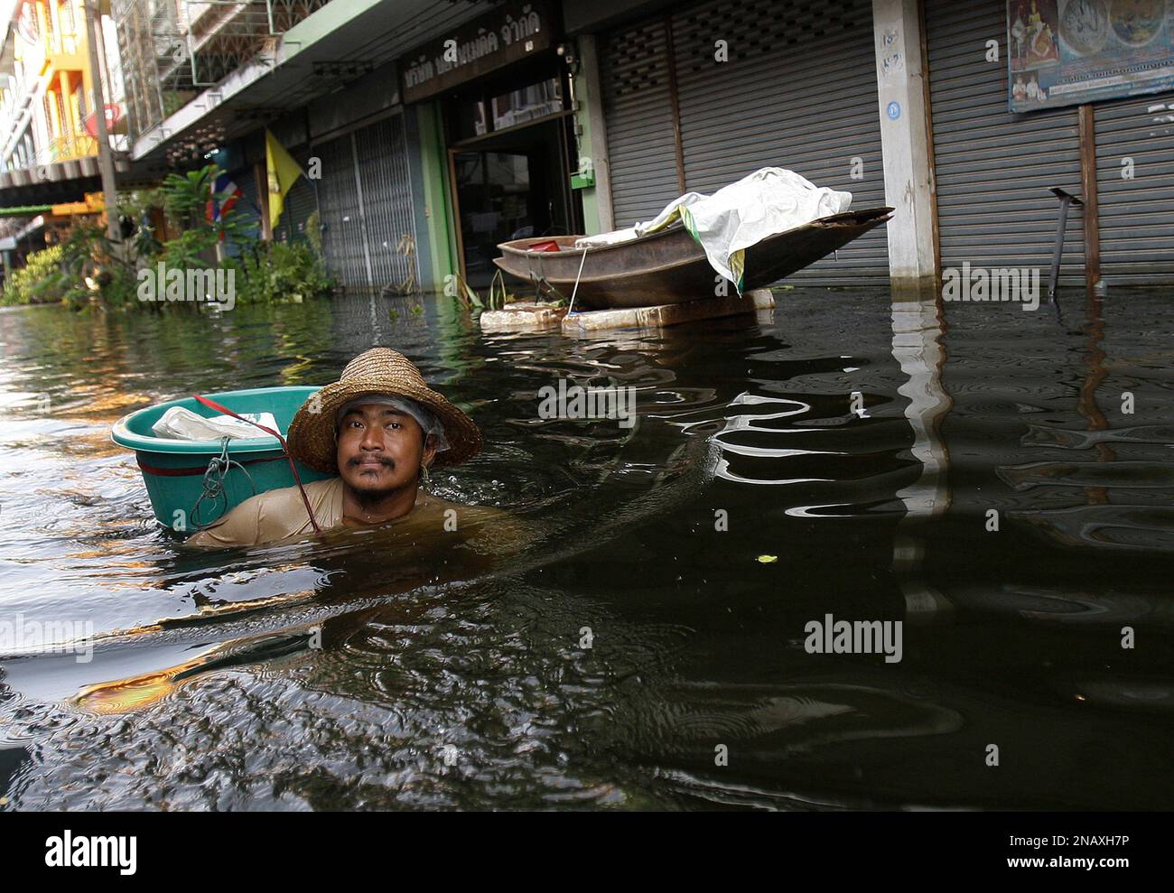 A Thai resident swims on neck-deep floodwaters in Bangkok, Thailand on ...