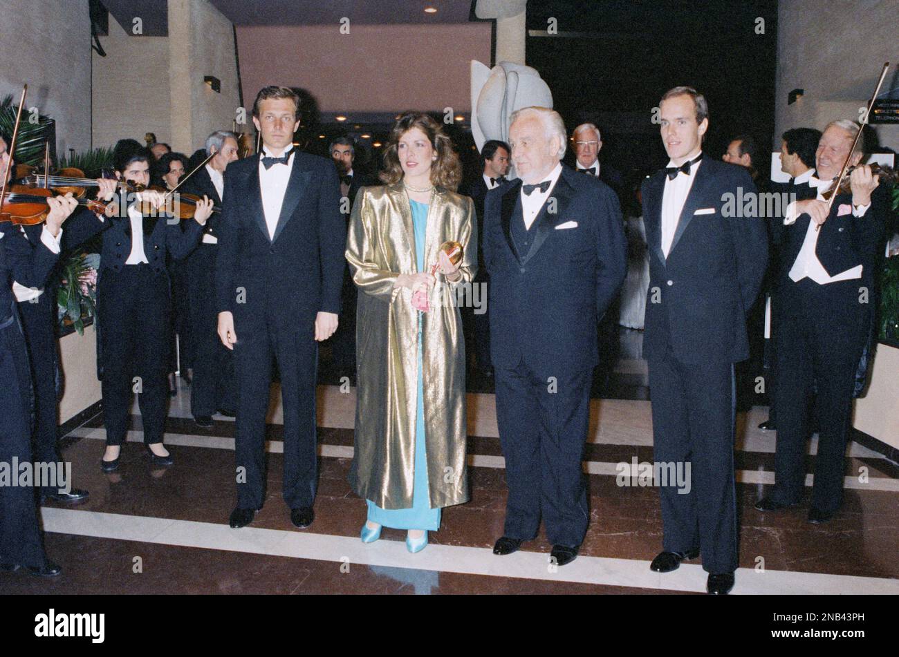 Princess Caroline wearing a wide gold coat over a turquoise blue ...