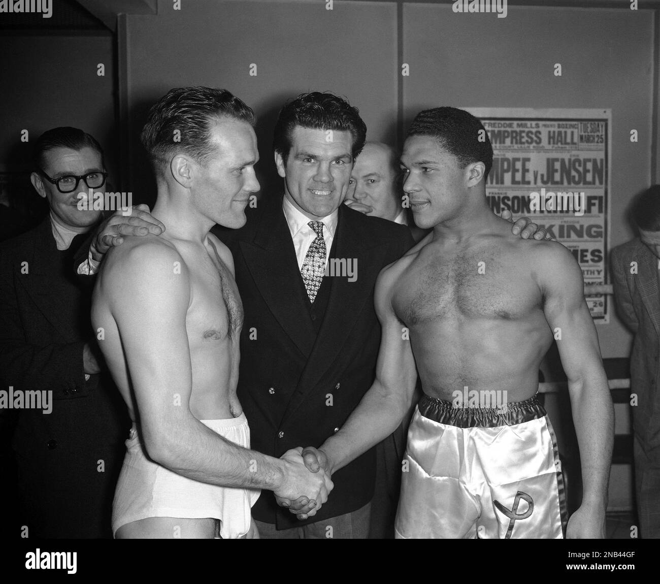 Retired British boxer and now promoter Freddie Mills, centre, is with ...