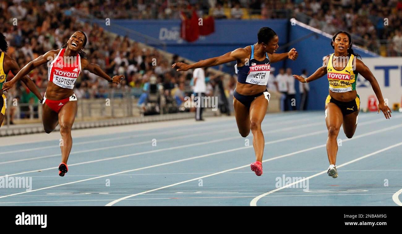 USA's Carmelita Jeter, center, crosses the finish line to win gold in ...