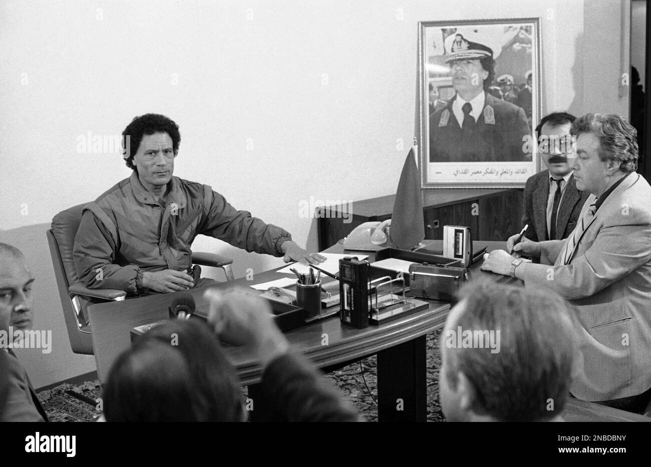 Libyan leader Col. Muammar Muhammad al-Gaddafi sits at his desk in ...