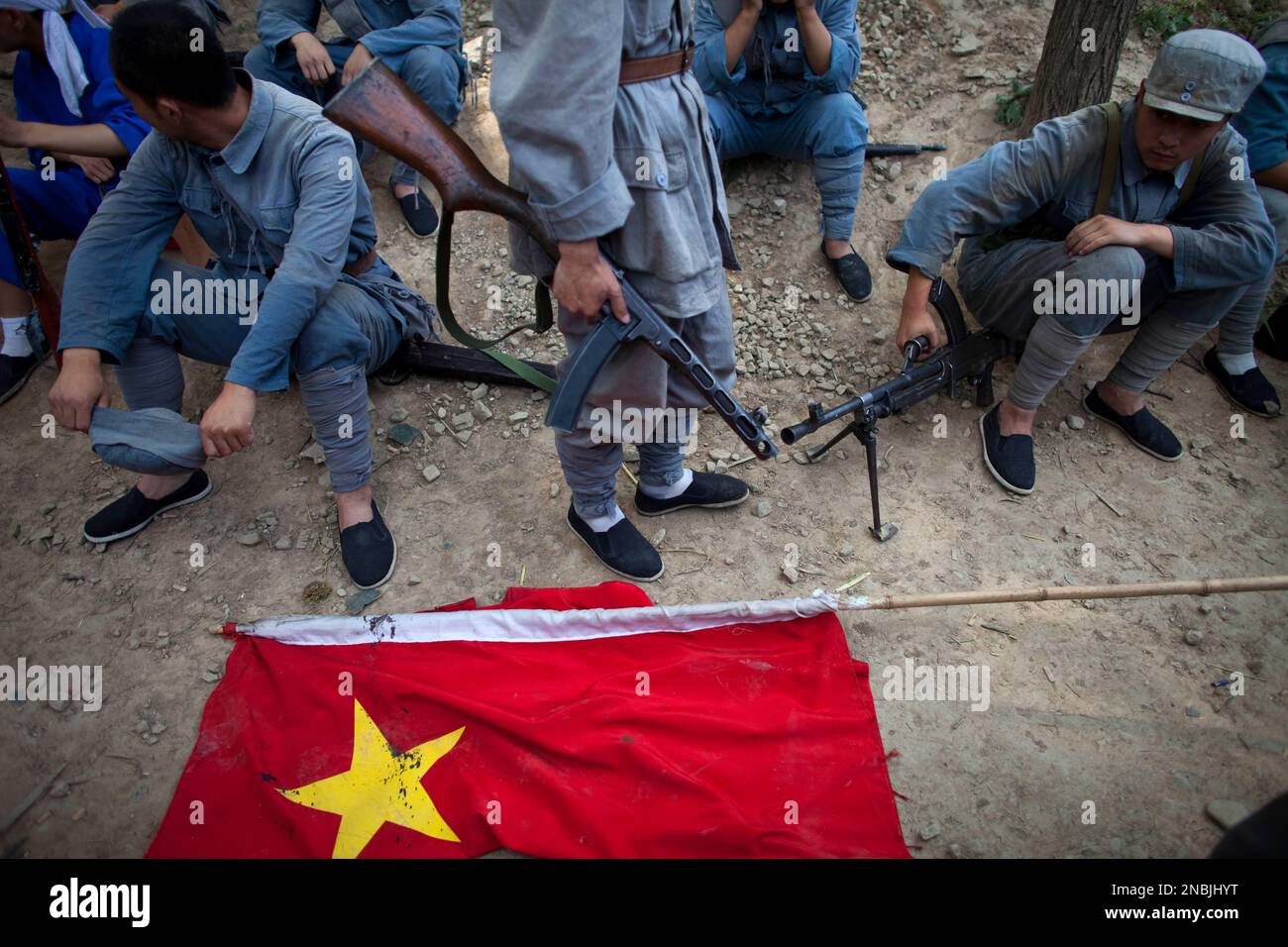 Actors dressed as a Communist Red Army soldiers prepare their weapons ...
