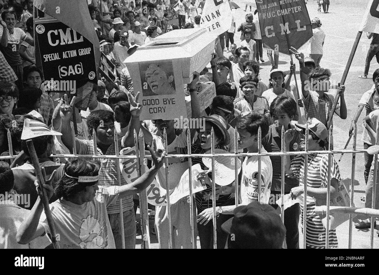 Supporters of deposed President Ferdinand E. Marcos carry an empty mock ...