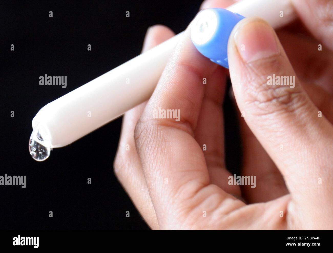 FILE - In this Oct. 28 2005 file photo, a drop of microbicide gel is ...