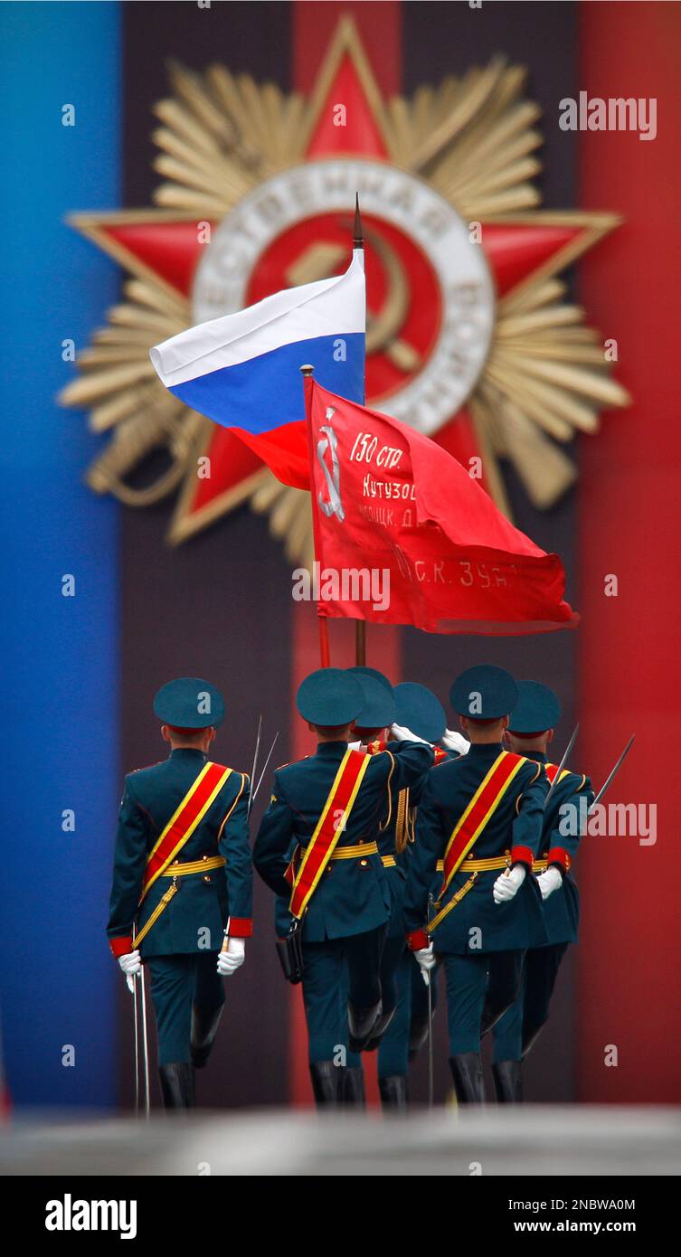 A Russian national flag, left, and a replica of the Victory banner ...