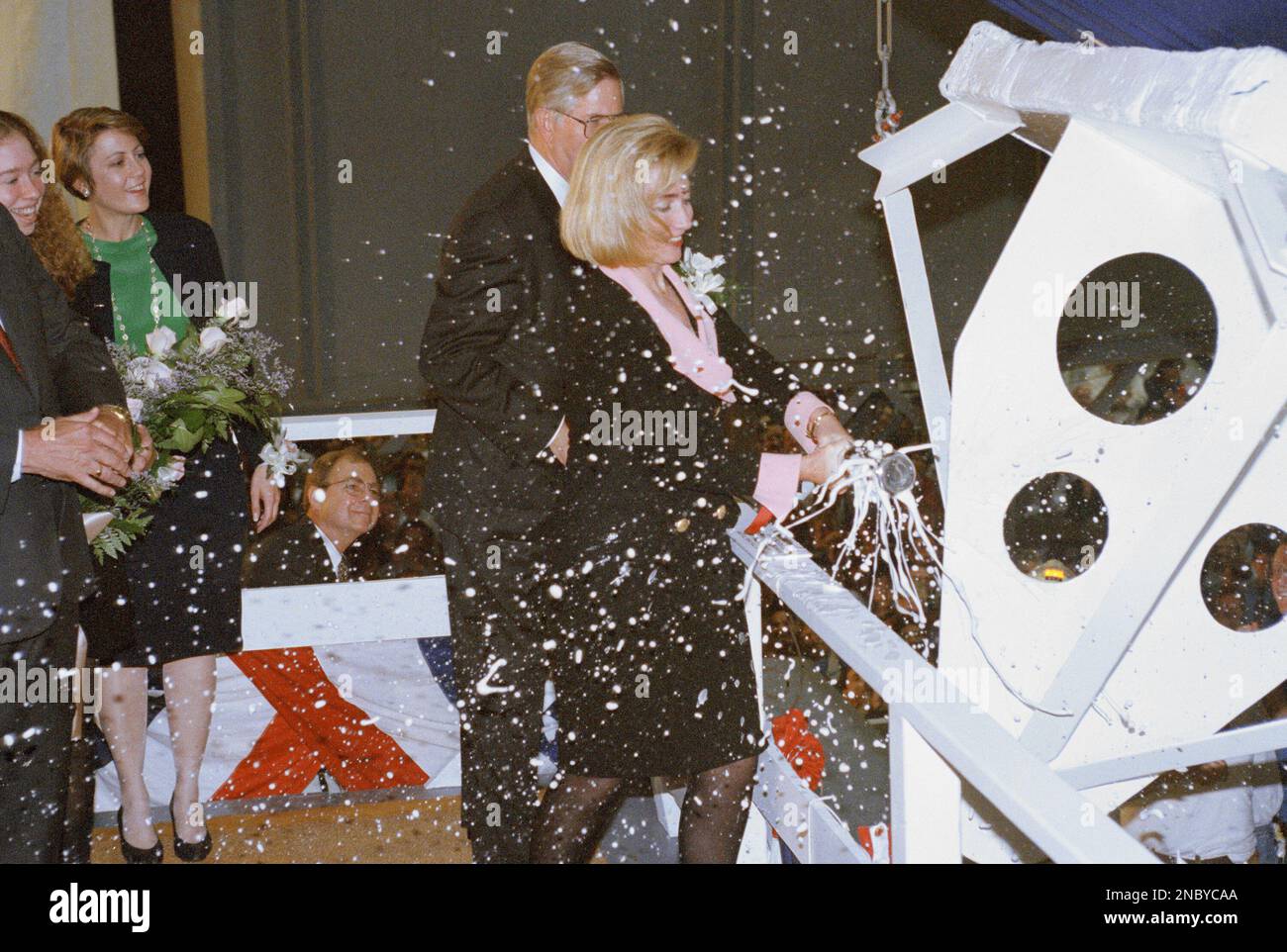 Hillary Rodham Clinton breaks a bottle of sparkling water on the Los ...