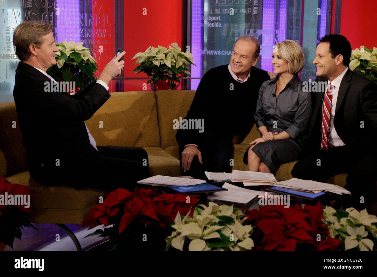 Co-host Steve Doocy, left, takes a photo of actor Kelsey Grammer ...
