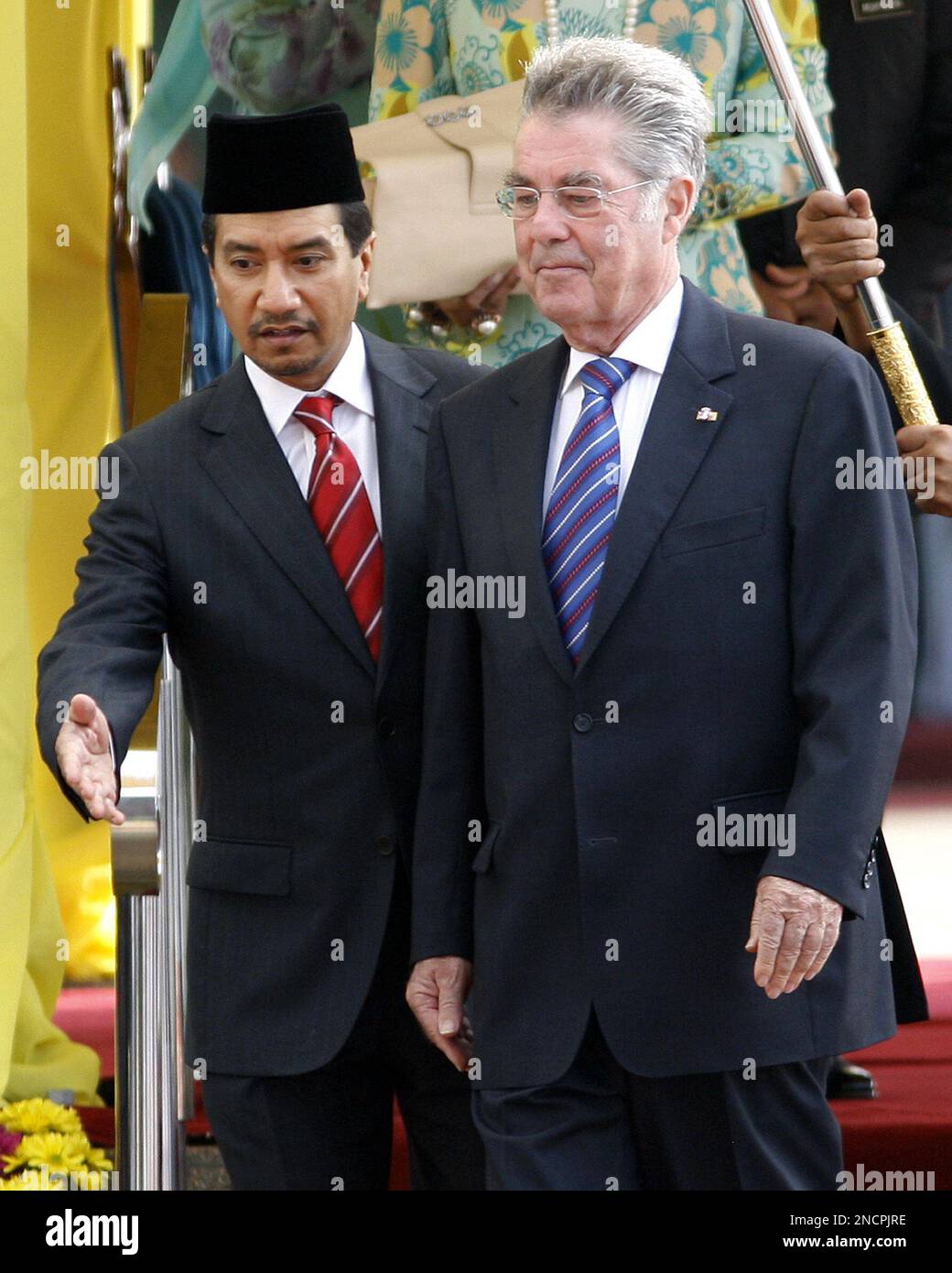 Austrian President Heinz Fischer, right, is guided by Malaysian King ...