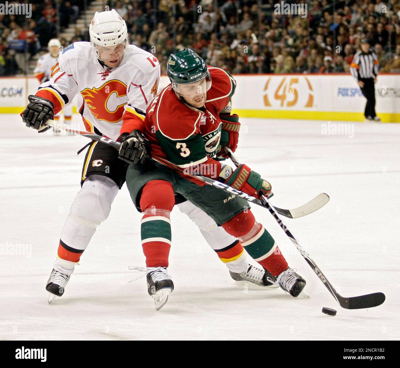 Calgary Flames winger Alex Tanguay, left, and Minnesota Wild defenseman ...