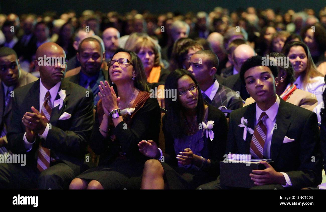 Angella Henry, second from left, mother of Danroy "D.J." Henry holds ...