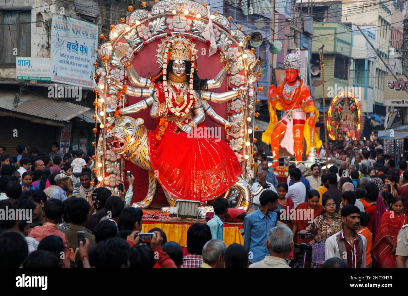 Tableaus carrying Hindu deities pass through the streets during a ...