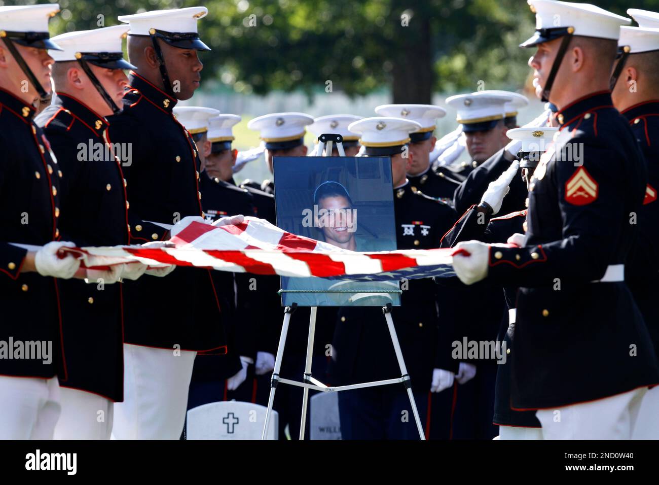 By a photograph of U.S. Marine Corps 1st Lt. Travis Manion, of ...