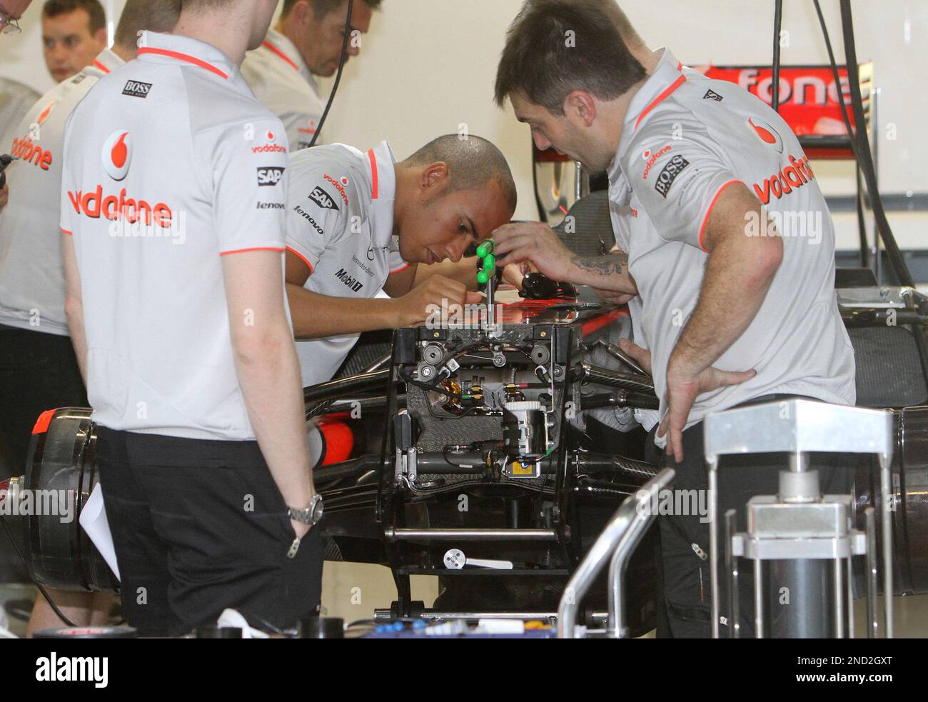 McLaren Formula One driver Lewis Hamilton, center, of Britain and his ...