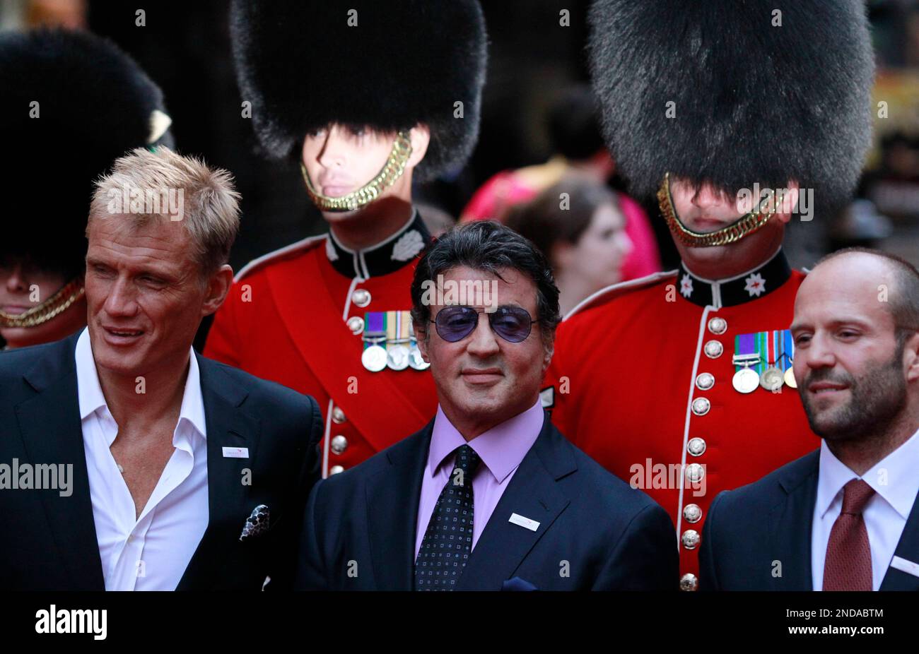 British soldiers wearing bearskin hats stand behind U.S actor Sylvester ...