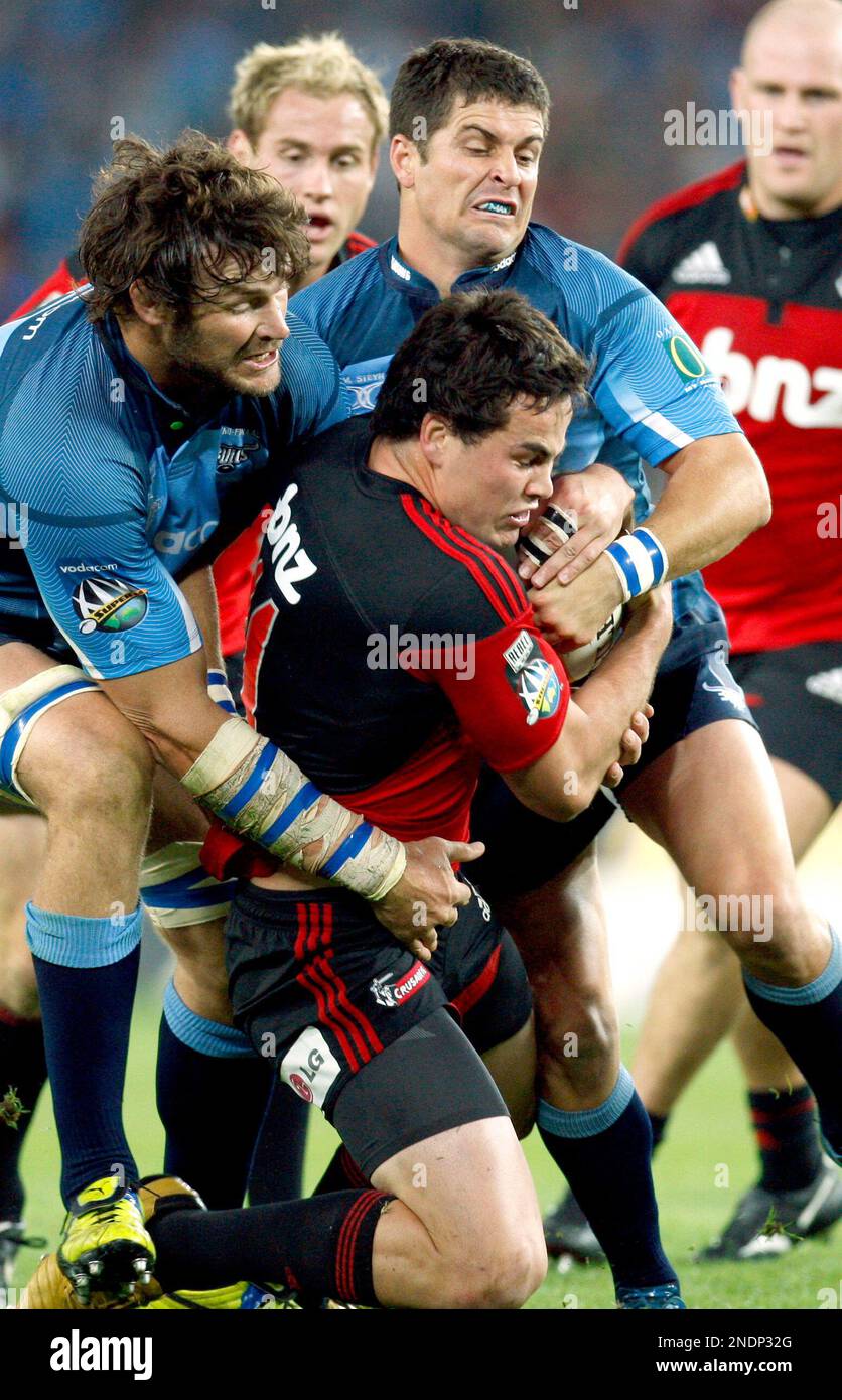 New Zealand Crusaders Zac Guildford, center, is tackled by South Africa ...