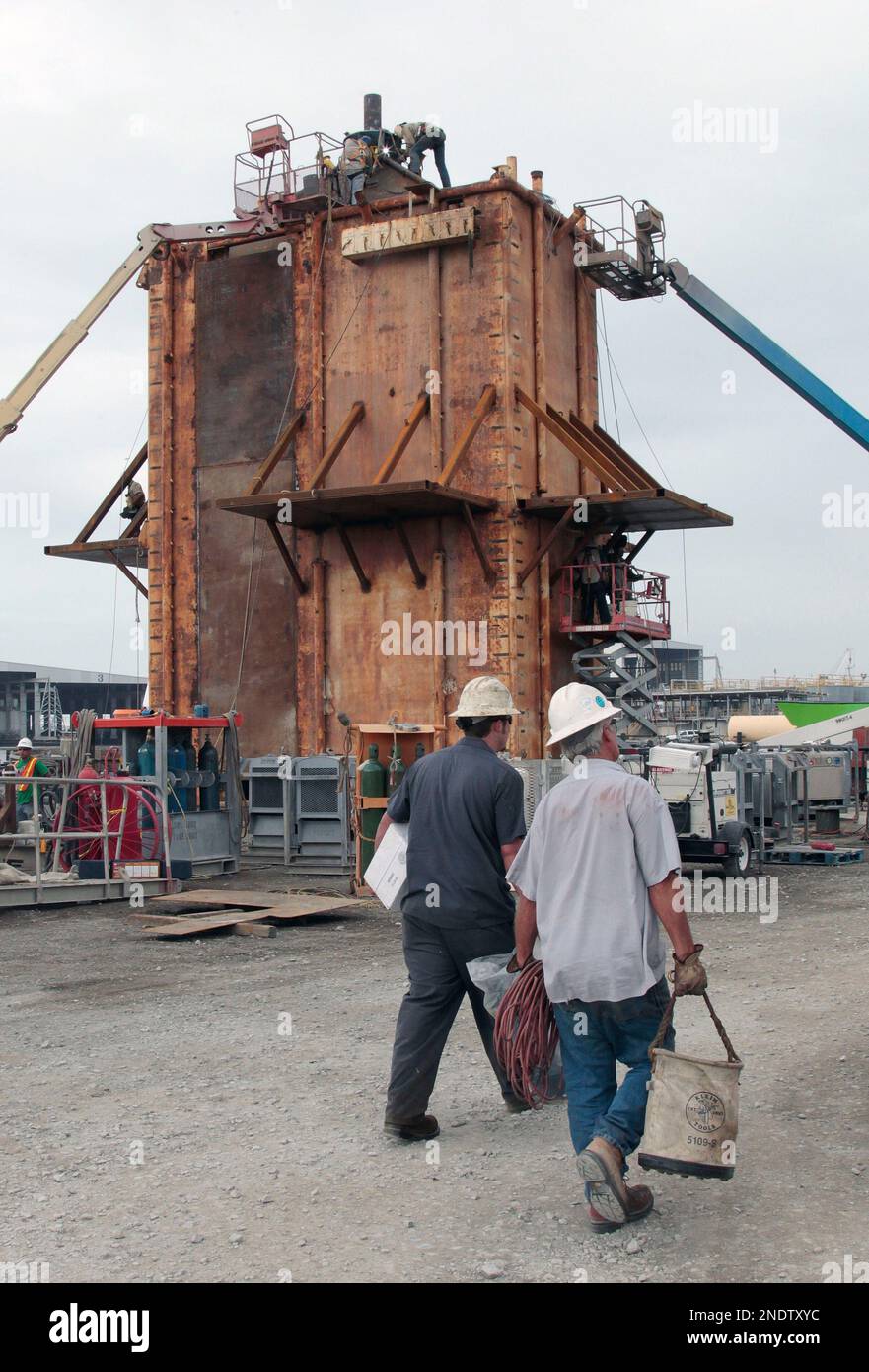 Workers at the Wild Well Control company work on a containment chamber ...