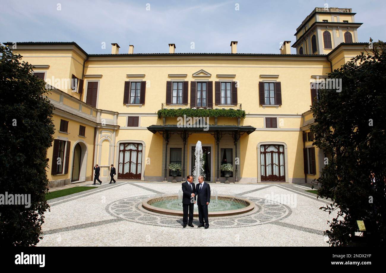 Italian Premier Silvio Berlusconi, center left, shakes hands with ...