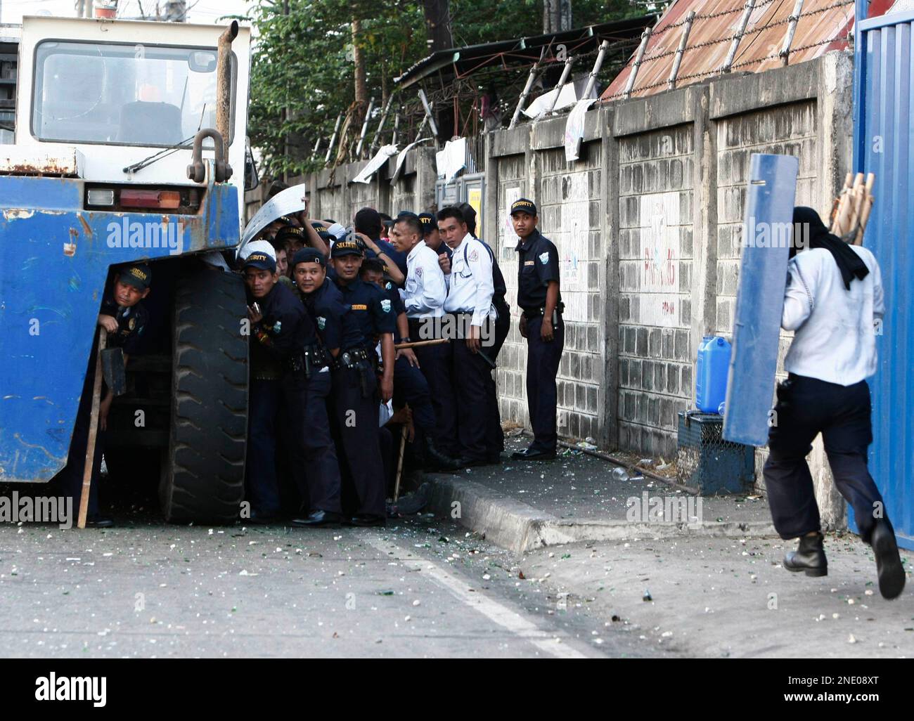 Private guards, fighting alongside with police take cover as they clash ...
