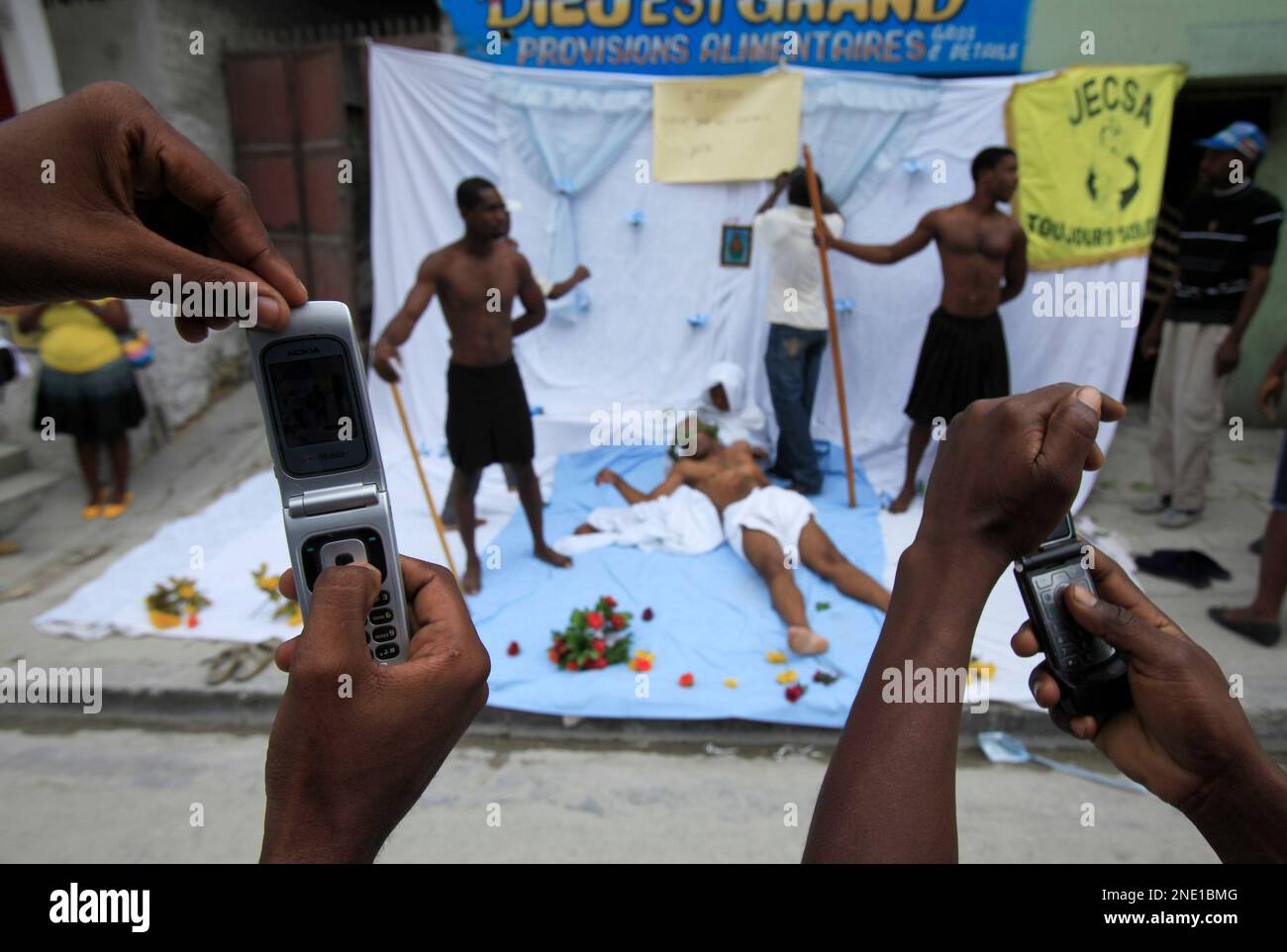 People use their cell phones to take pictures of actors who perform a ...