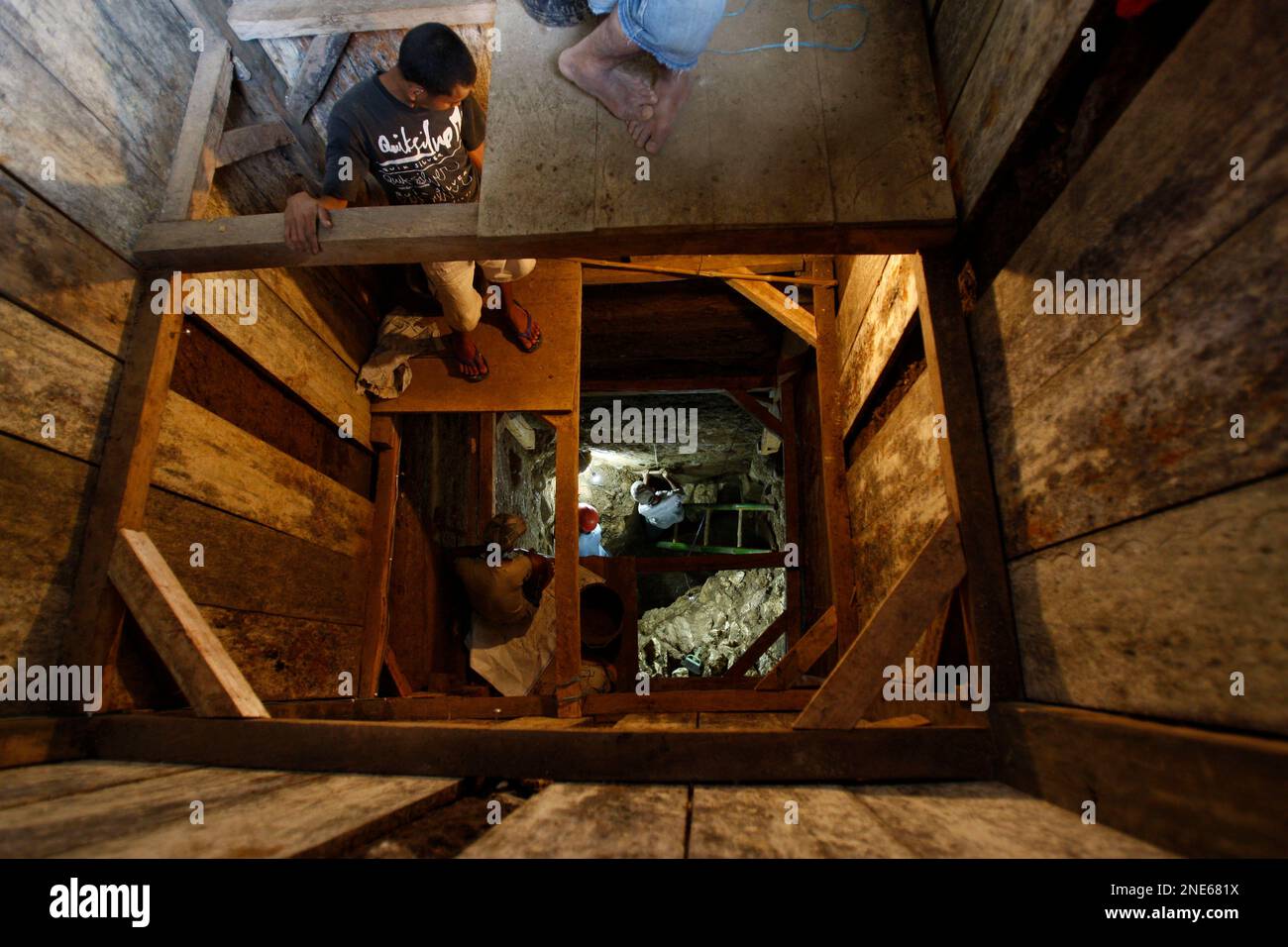 In this photo taken Sept. 14, 2009, workers labor at the Liang Bua cave ...