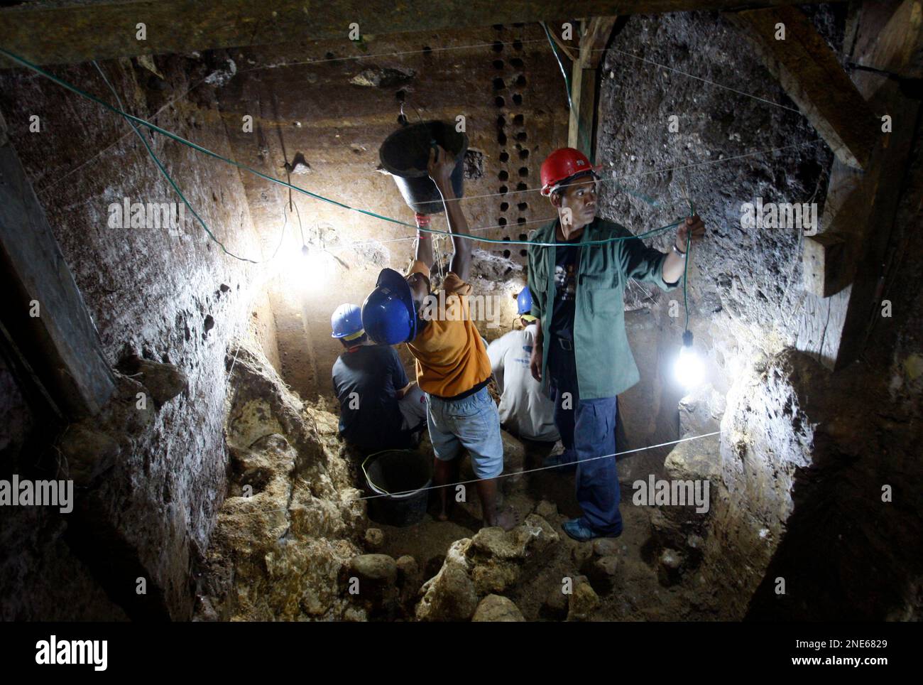 In this photo taken Sept. 14, 2009, workers labor at the Liang Bua cave ...