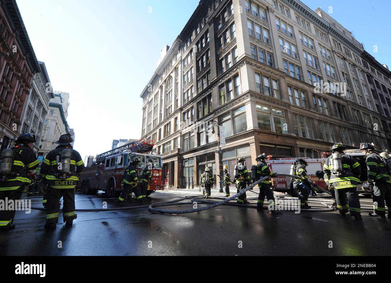 Firefighters tend to the aftermath of a fire at Sixth Avenue and 20th ...