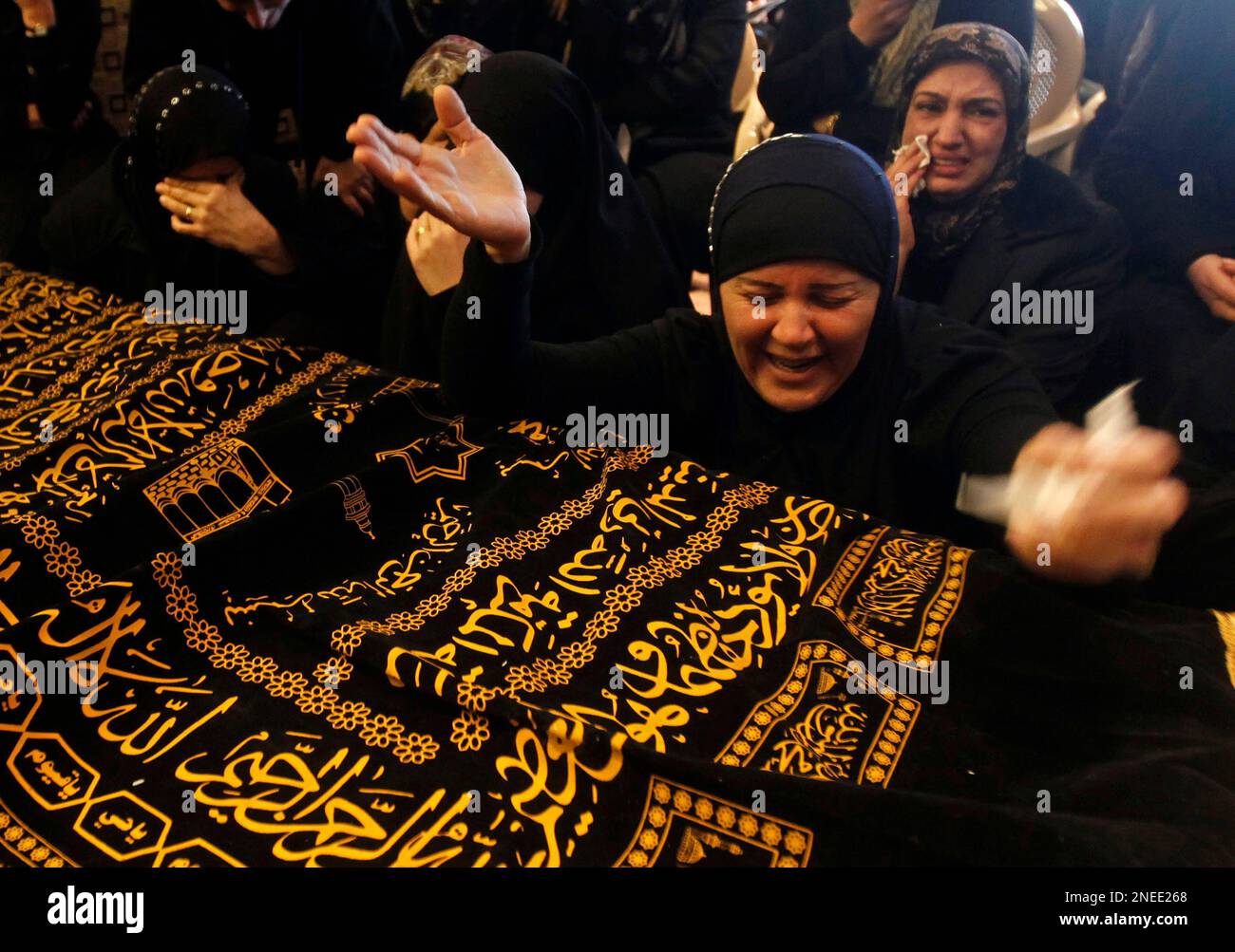 Lebanese Nejmeh Tajeddine mourns over the coffin of her husband ...