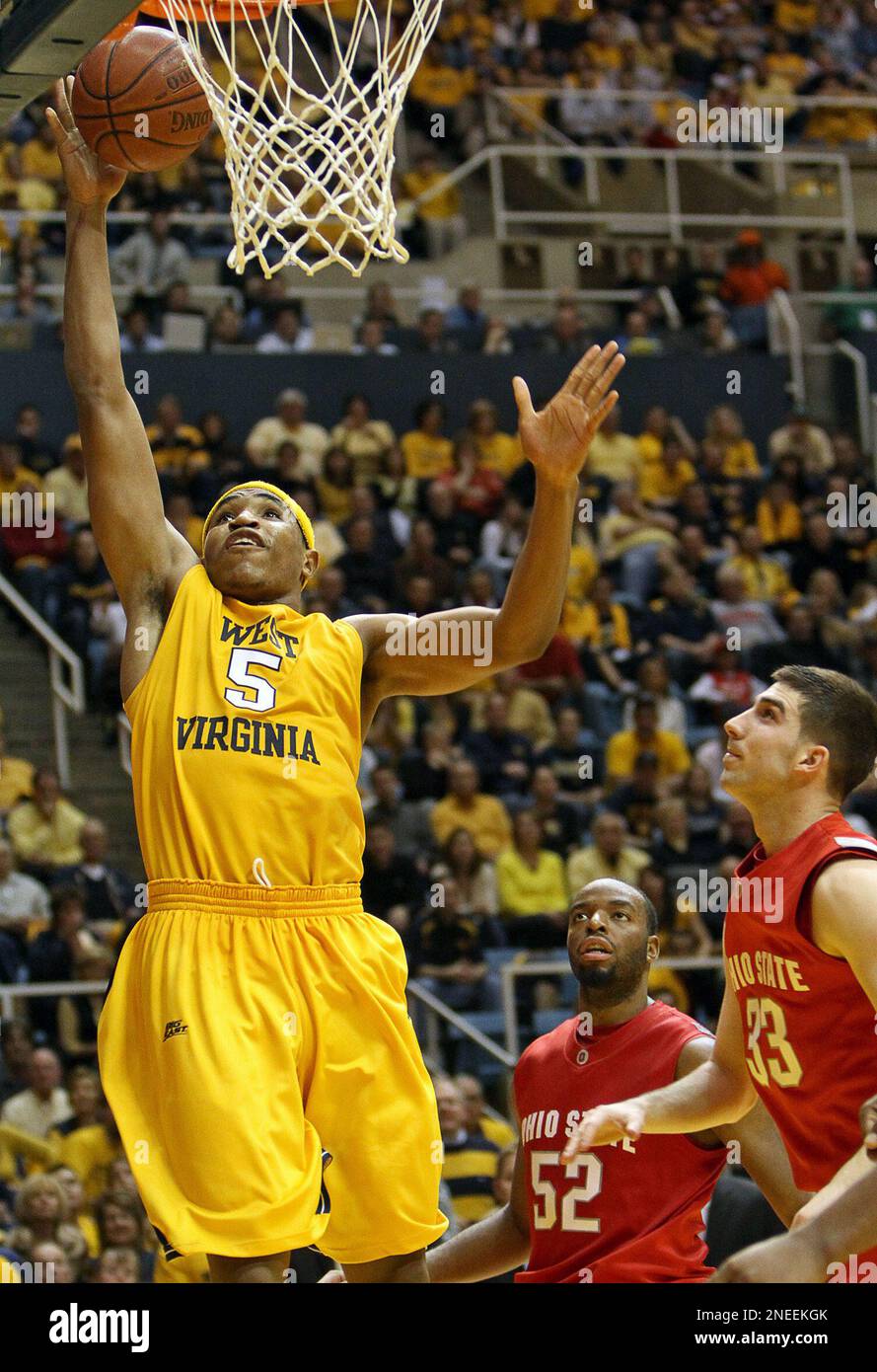 West Virginia's Kevin Jones (5) shoots a layup over Ohio State's Jon ...