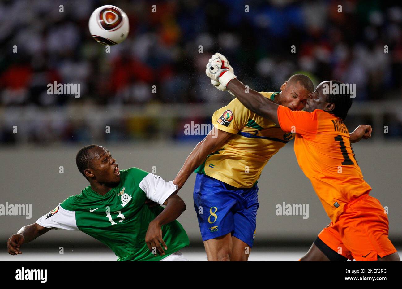 Gabon's captain Daniel Cousin, center, collides with Zambia's ...