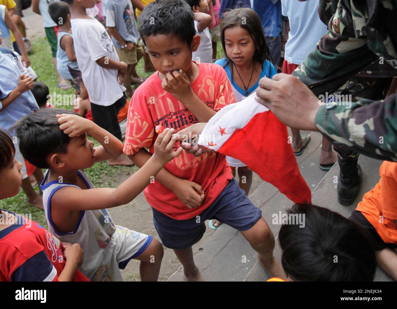 A soldier from the Philippine Army's 901st Brigade distributes candies ...