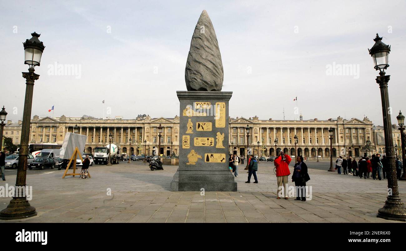 People walk on the Concorde square in paris where a fake menhir ...