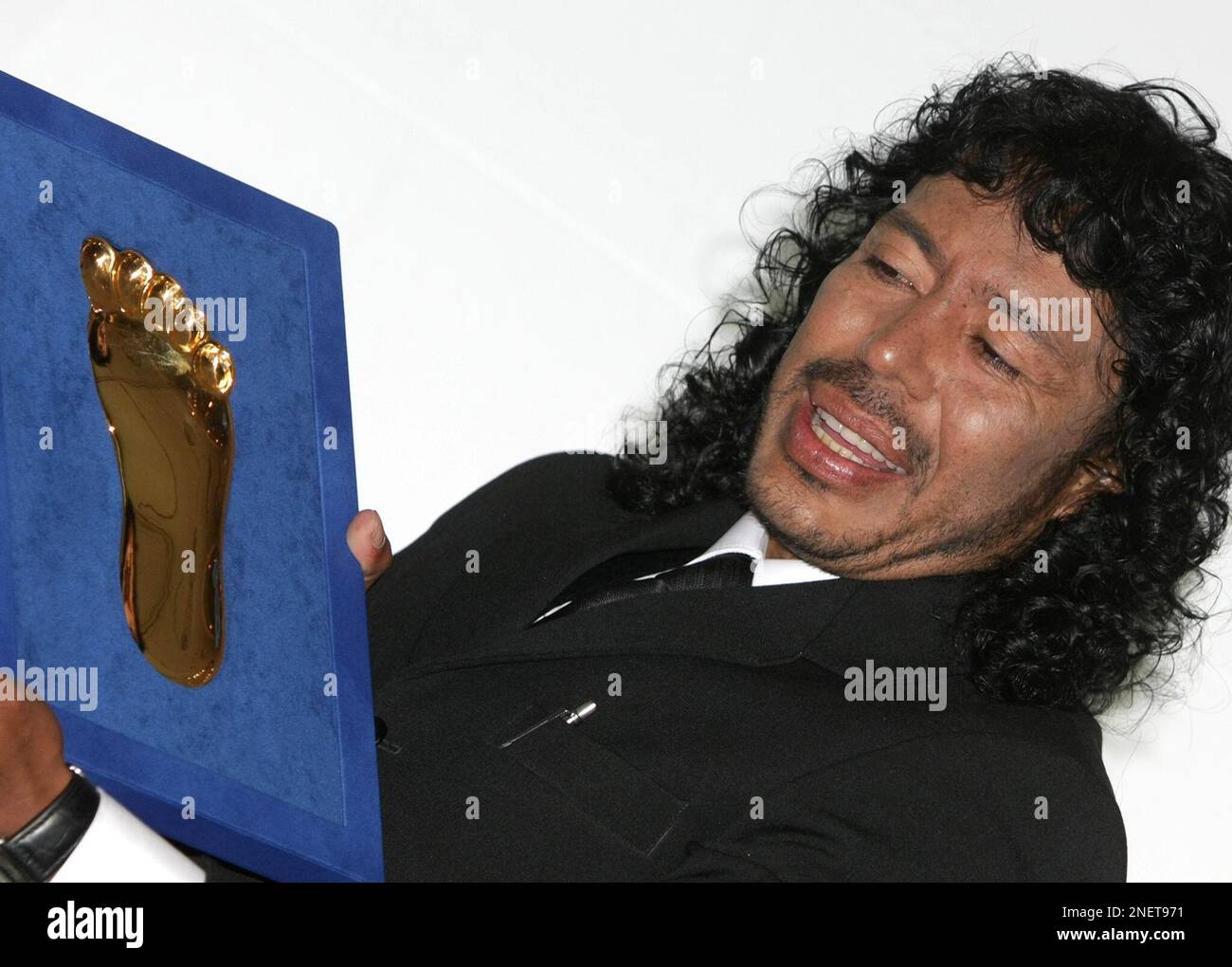 Former Colombian goalkeeper Rene Higuita poses with his "Golden Foot ...