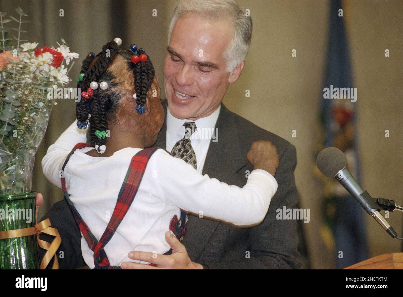 District Attorney Gil Garcetti, right, gives a hug to Alisha Parker ...
