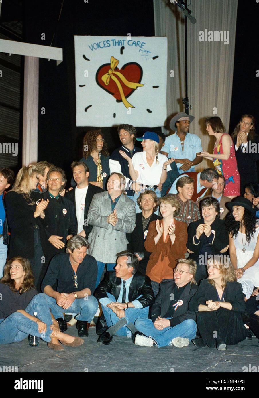 Part of a group of over 100 celebrities sing along to a previously ...