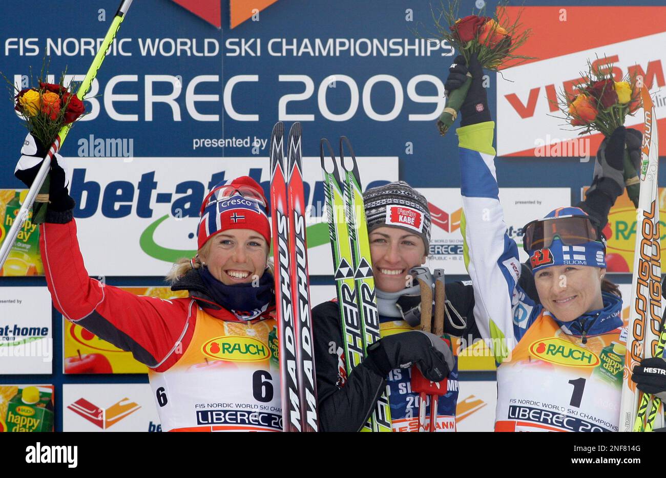 Poland's gold medal winner Justyna Kowalczyk is flanked by Norway's ...